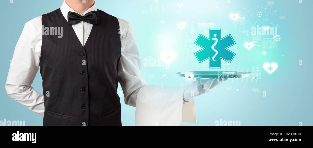 Handsome young waiter in tuxedo holding healthcare icons on tray Stock ...