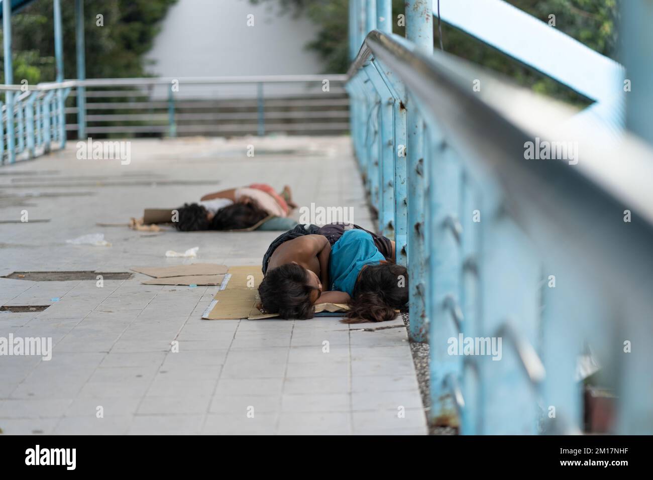 Homeless Street children on a flyover sleeping on cardboard used as ...
