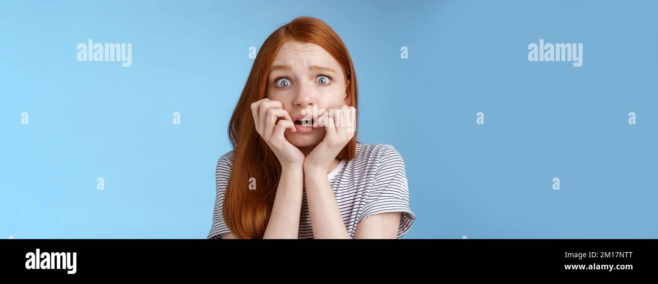Scared speechless stunned frightened redhead girl trembling fear wide ...