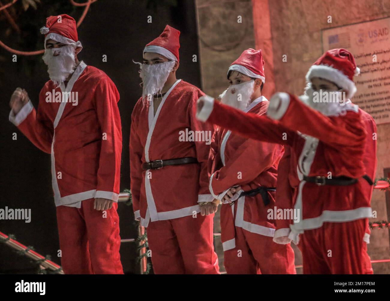 Palestinian children dressed as Santa Claus attend a Christmas tree ...