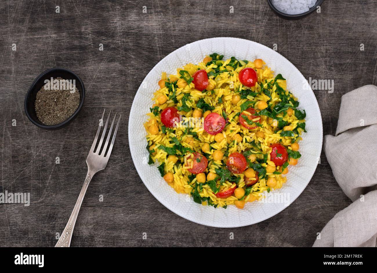 Chinese fried rice with turmeric, chickpeas, tomatoes and kale on a ...