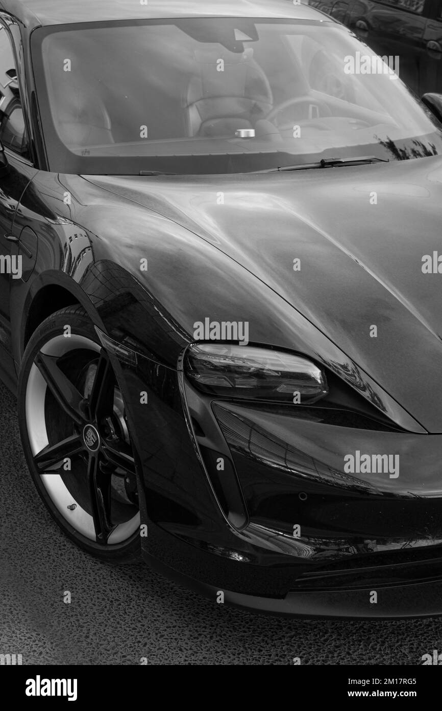 A vertical of Porsche parked on the street shot in grayscale Stock ...