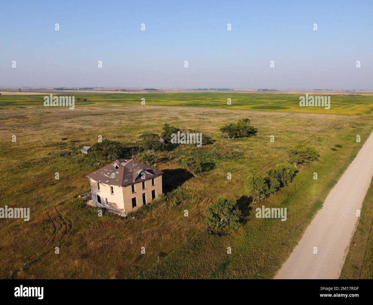 A bird's eye view of an abandoned farmhouse in the prairies of ...