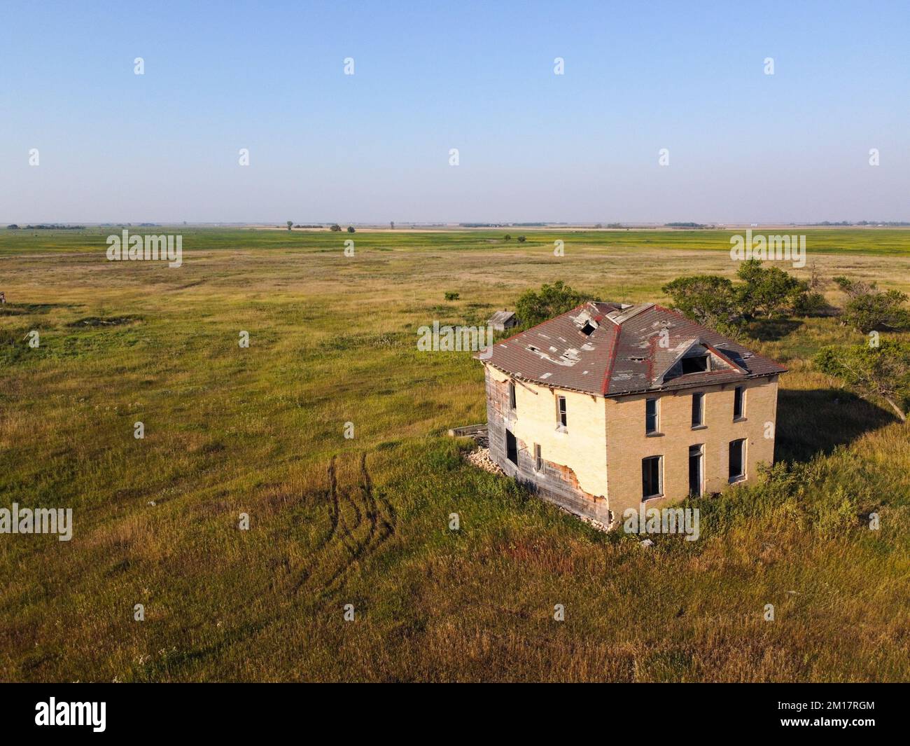 A bird's eye view of an abandoned farmhouse in the prairies of ...