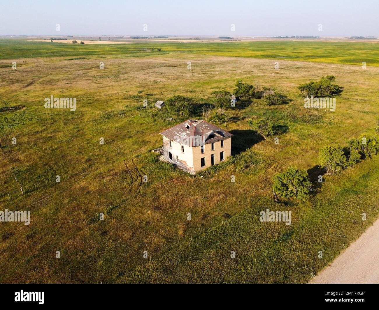 A bird's eye view of an abandoned farmhouse in the prairies of ...