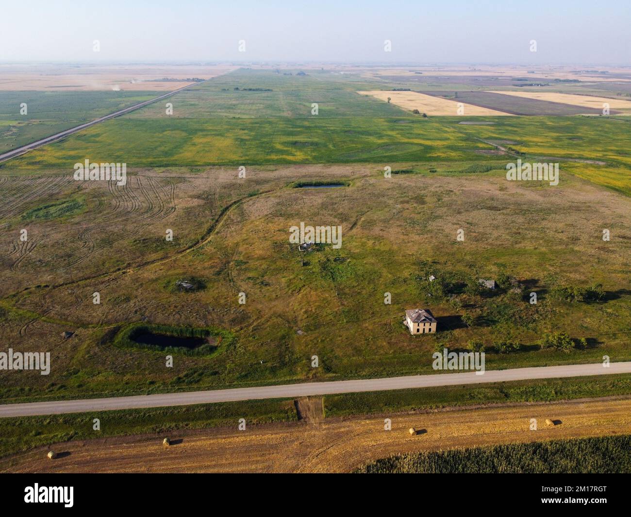 A bird's eye view of an abandoned farmhouse in the prairies of ...