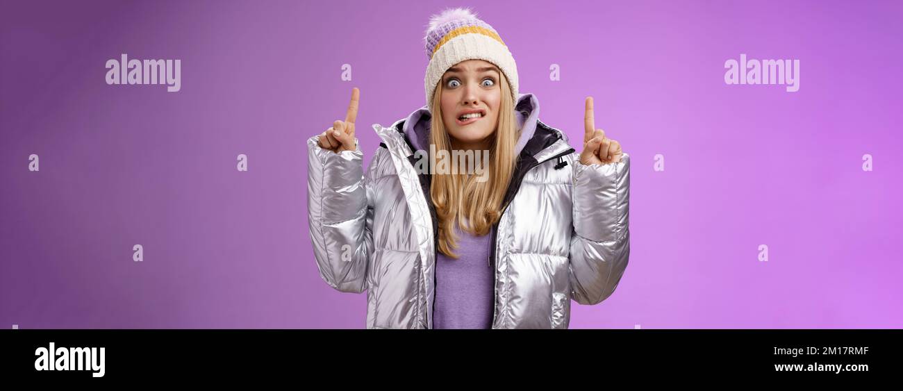 Scared unsure worried awkward young cute blond girl biting lip stooping ...