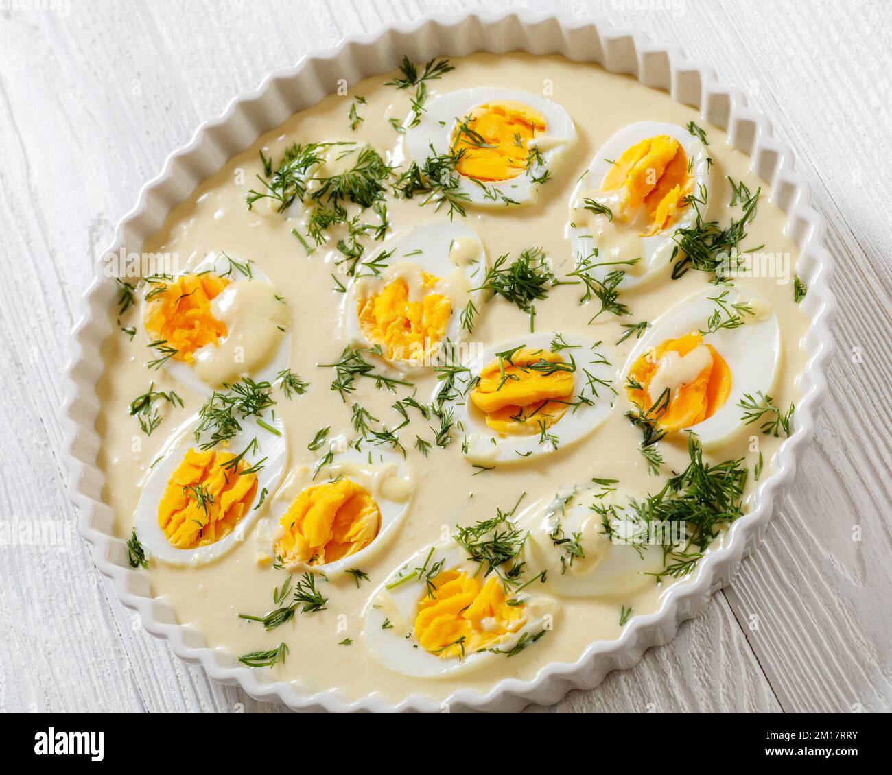 Senfeier, hard boiled eggs in rich creamy mustard sauce in white baking ...