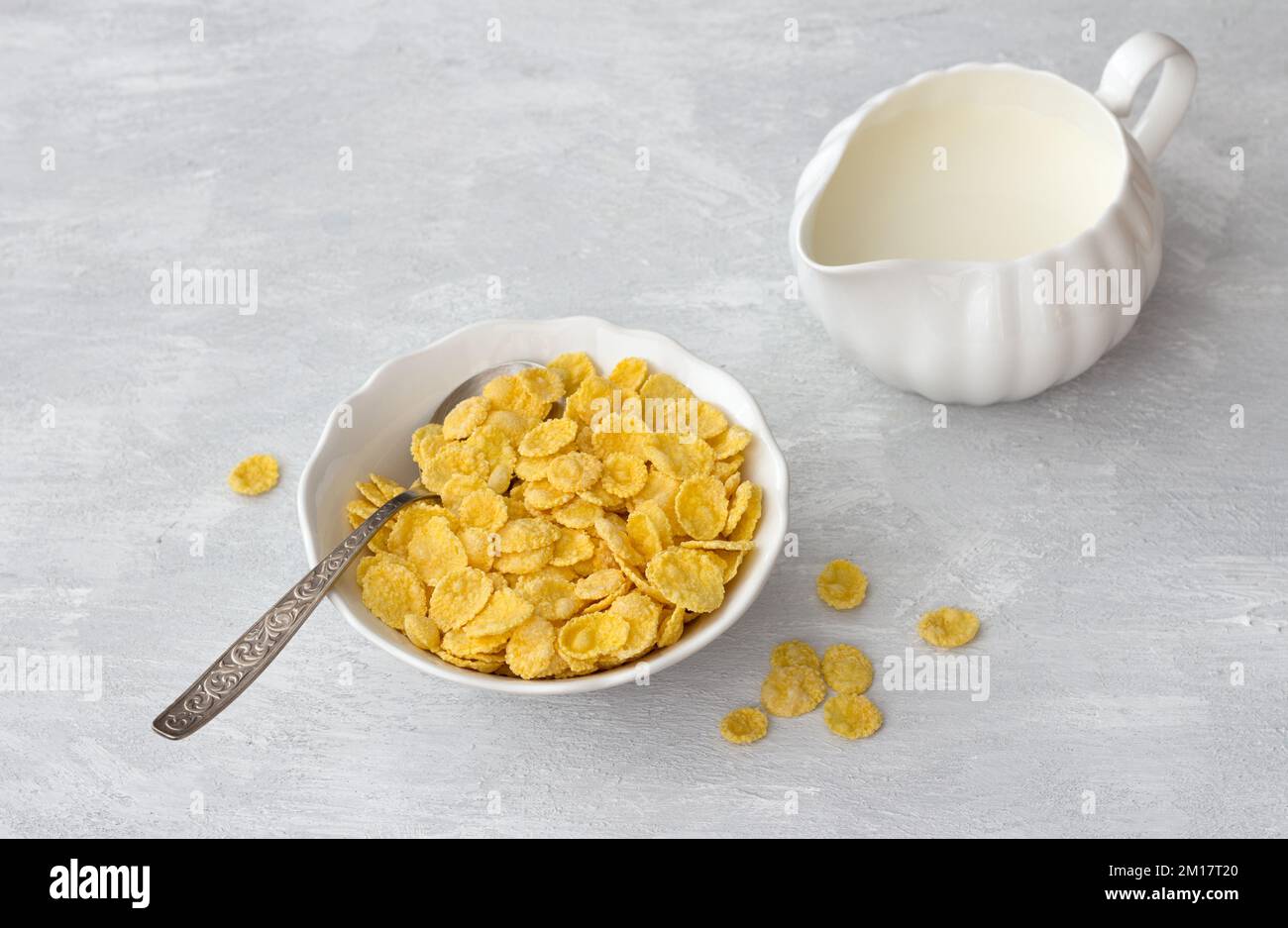Sweet crunchy cornflakes on a gray textured background. Fast tasty ...