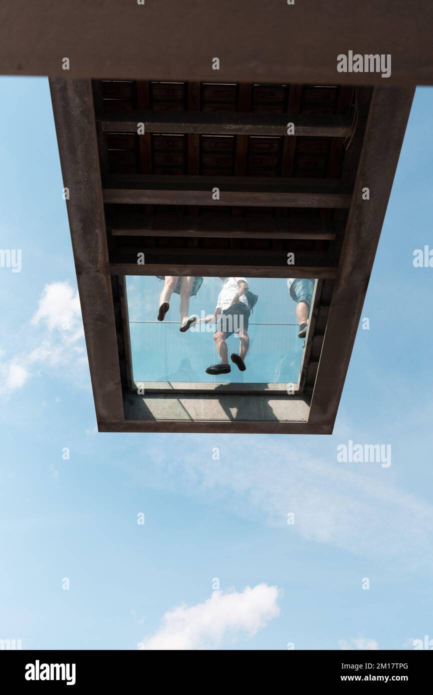 A low anglw of people standing on transparent Salling Rooftop in Aarhus ...