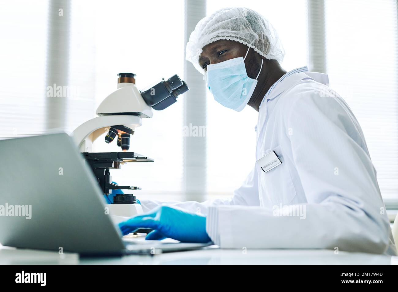 Side view portrait of black man as scientist doing research in medical ...