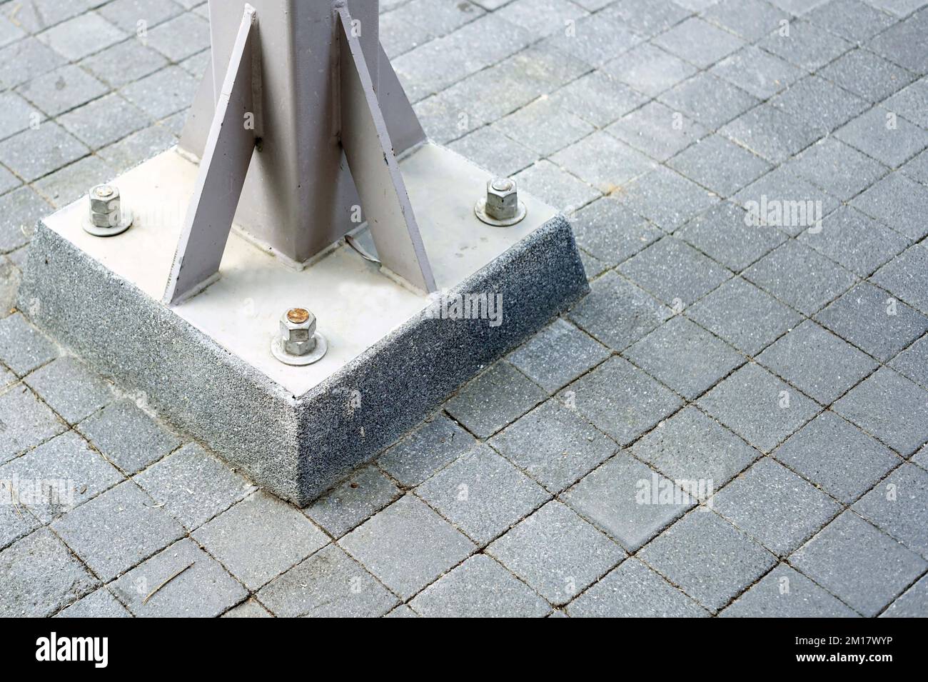 A cement base with installed the steel pole around footpath area Stock ...