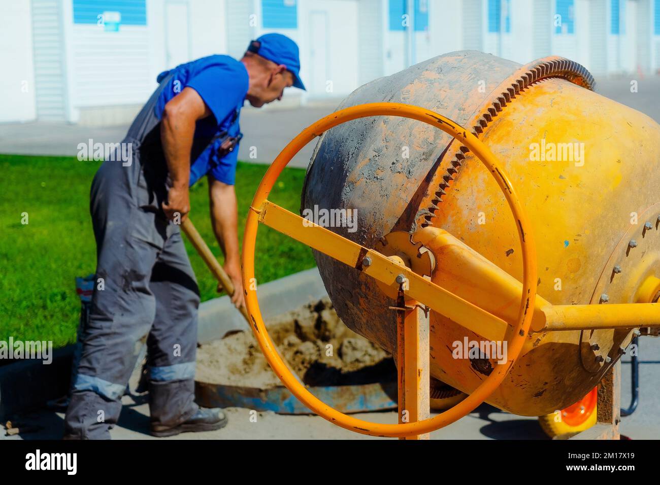 Uniformed construction worker works on construction site on summer day ...