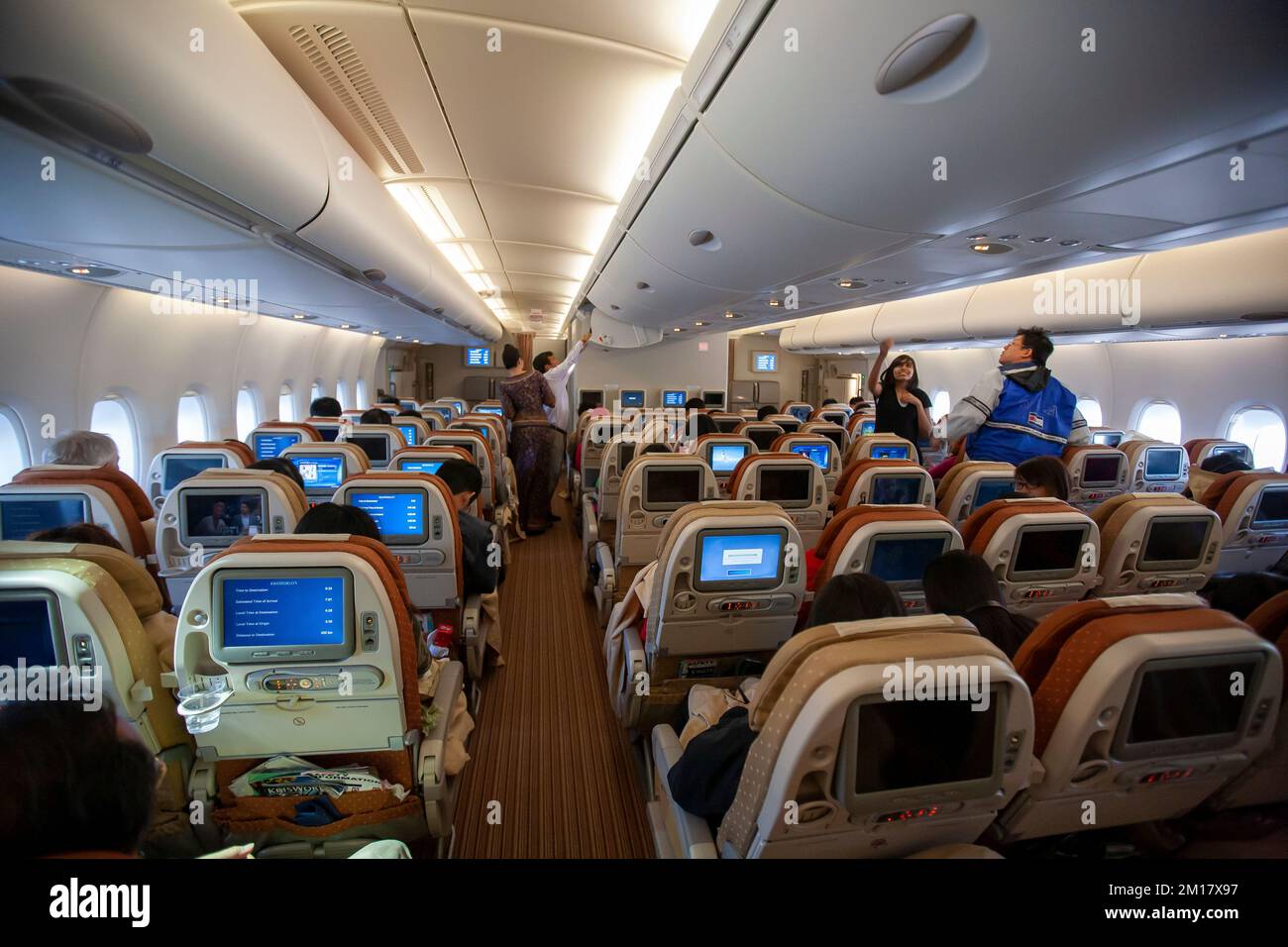 passengers in an international flight watching flight tv monitor Stock ...