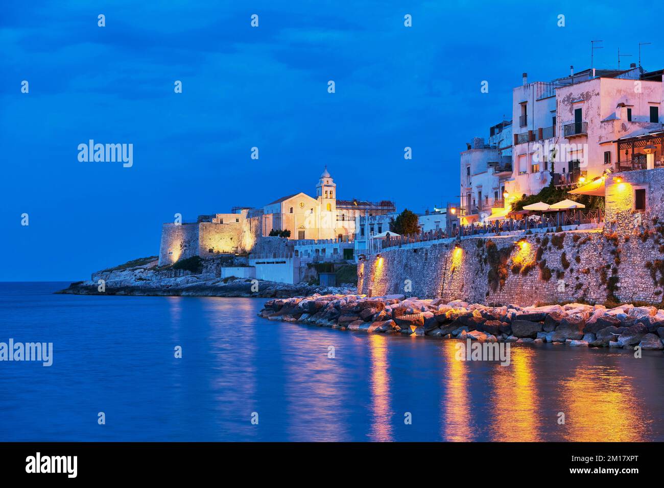 Punta San Francesco with illuminated church of San Francesco and old ...