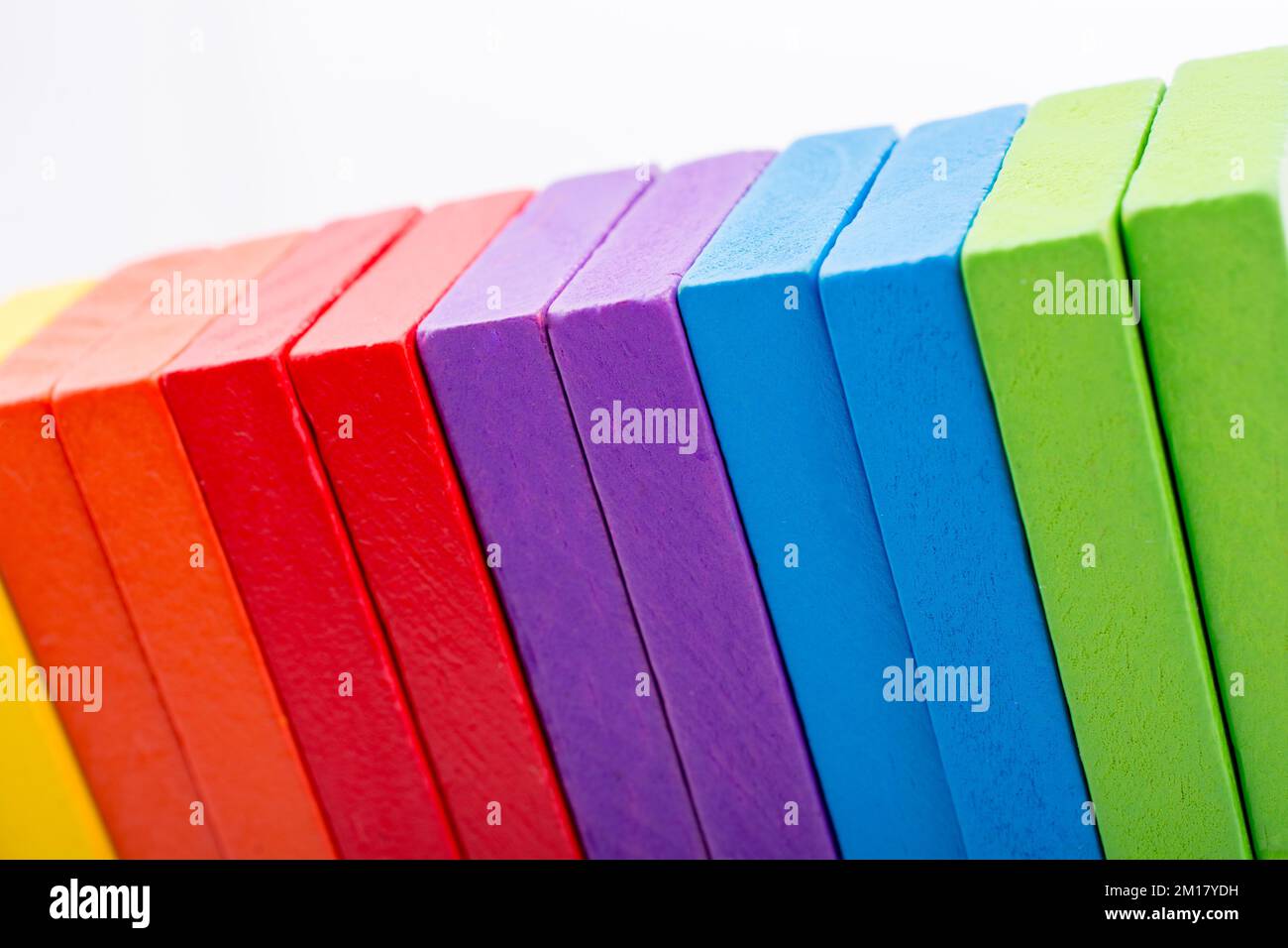 Colorful Domino Blocks in a line on a white background Stock Photo - Alamy