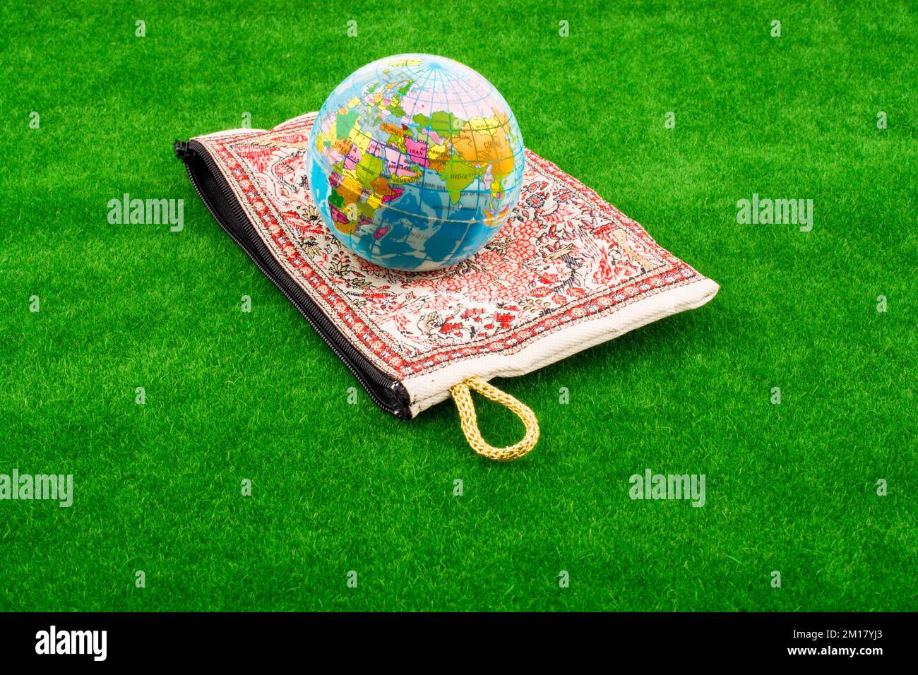 Globe in a traditional purse on green grass Stock Photo - Alamy