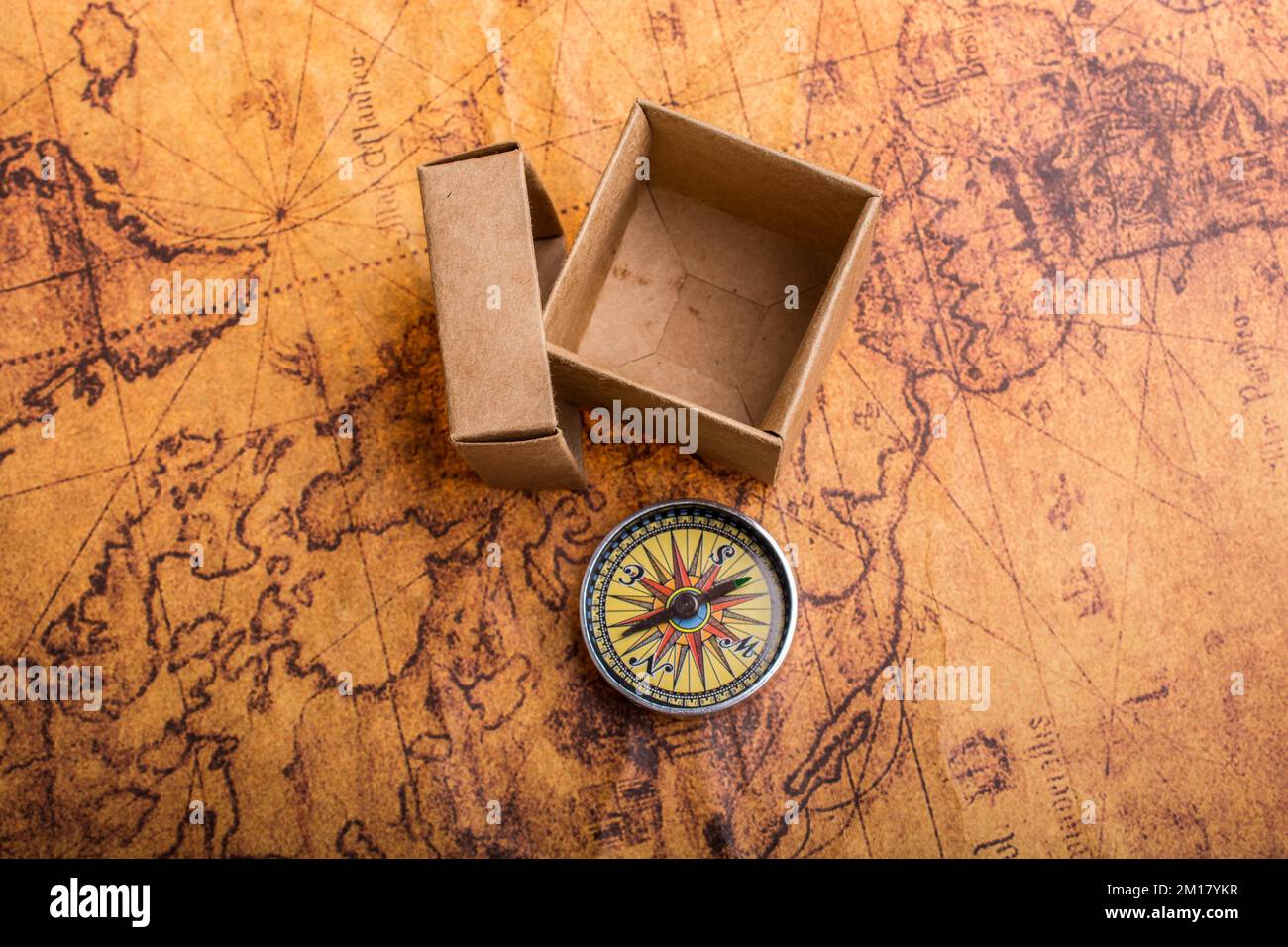 Compass on old map beside a box as a concept of traveling Stock Photo ...