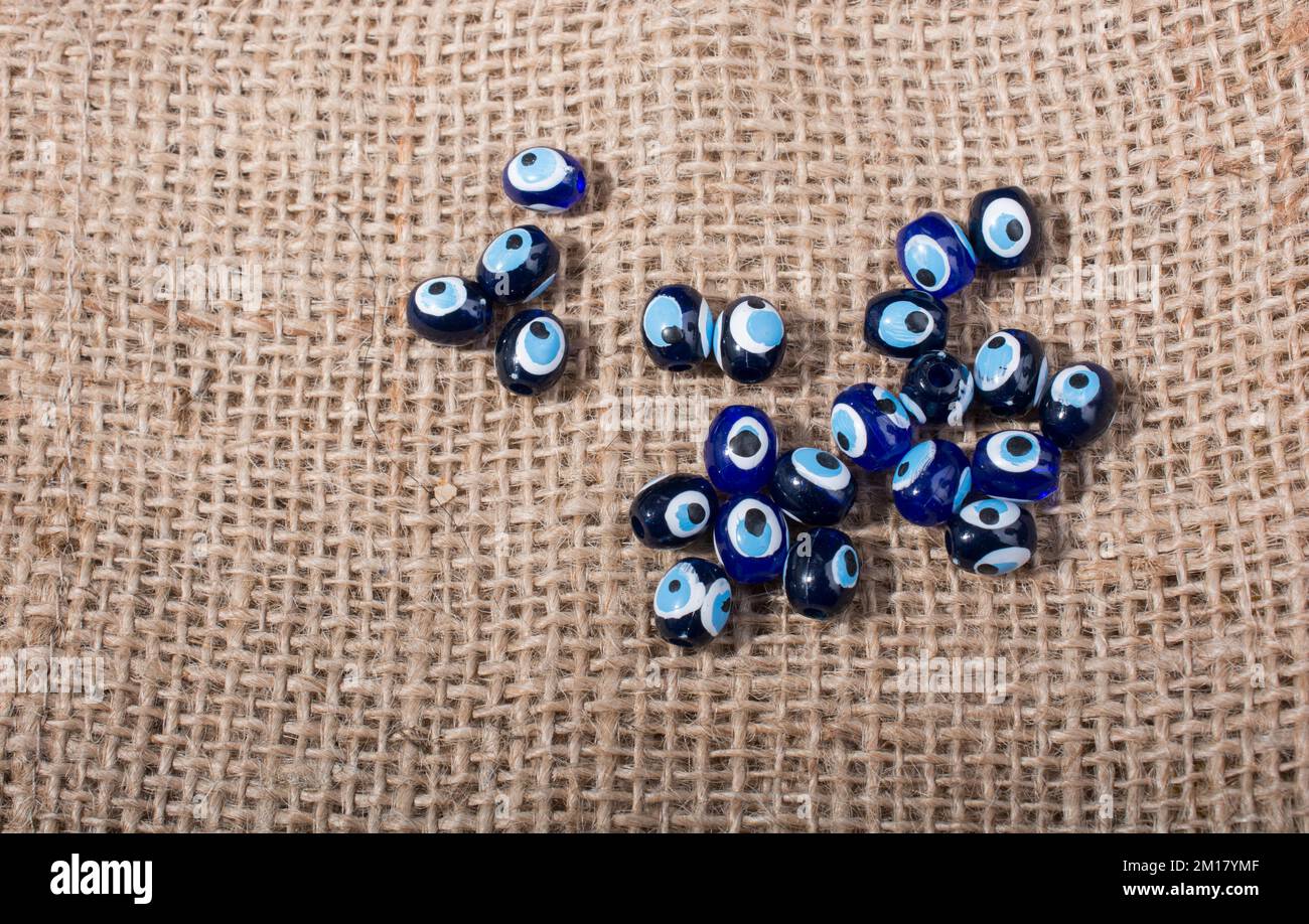 Turkish evil eye beads on canvas texture fabric Stock Photo - Alamy