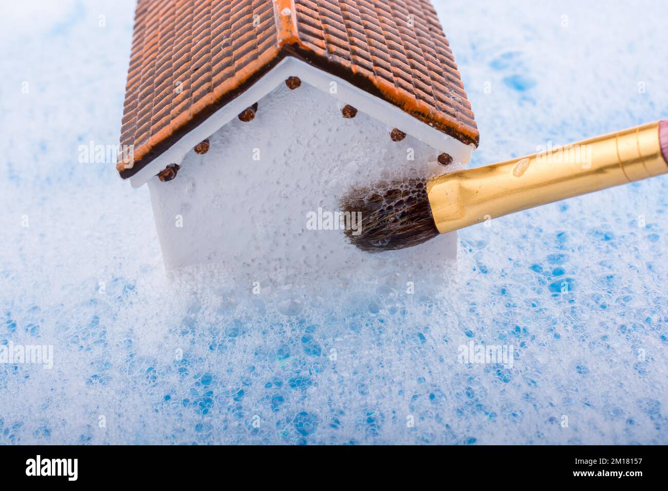 Little model house and a painting brush in foamy water Stock Photo - Alamy