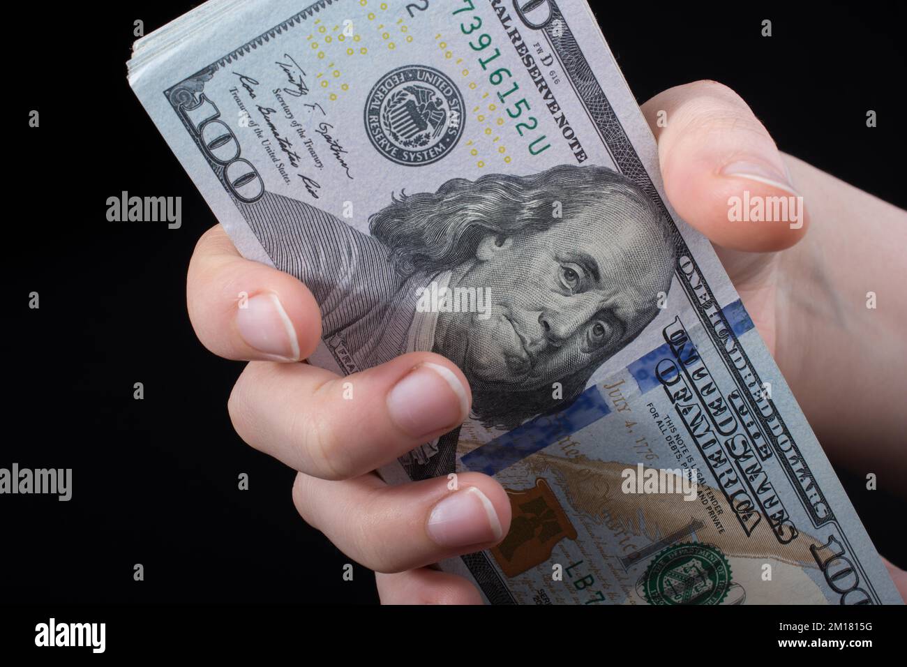 Hand holding American dollar banknotes isolated on white background ...