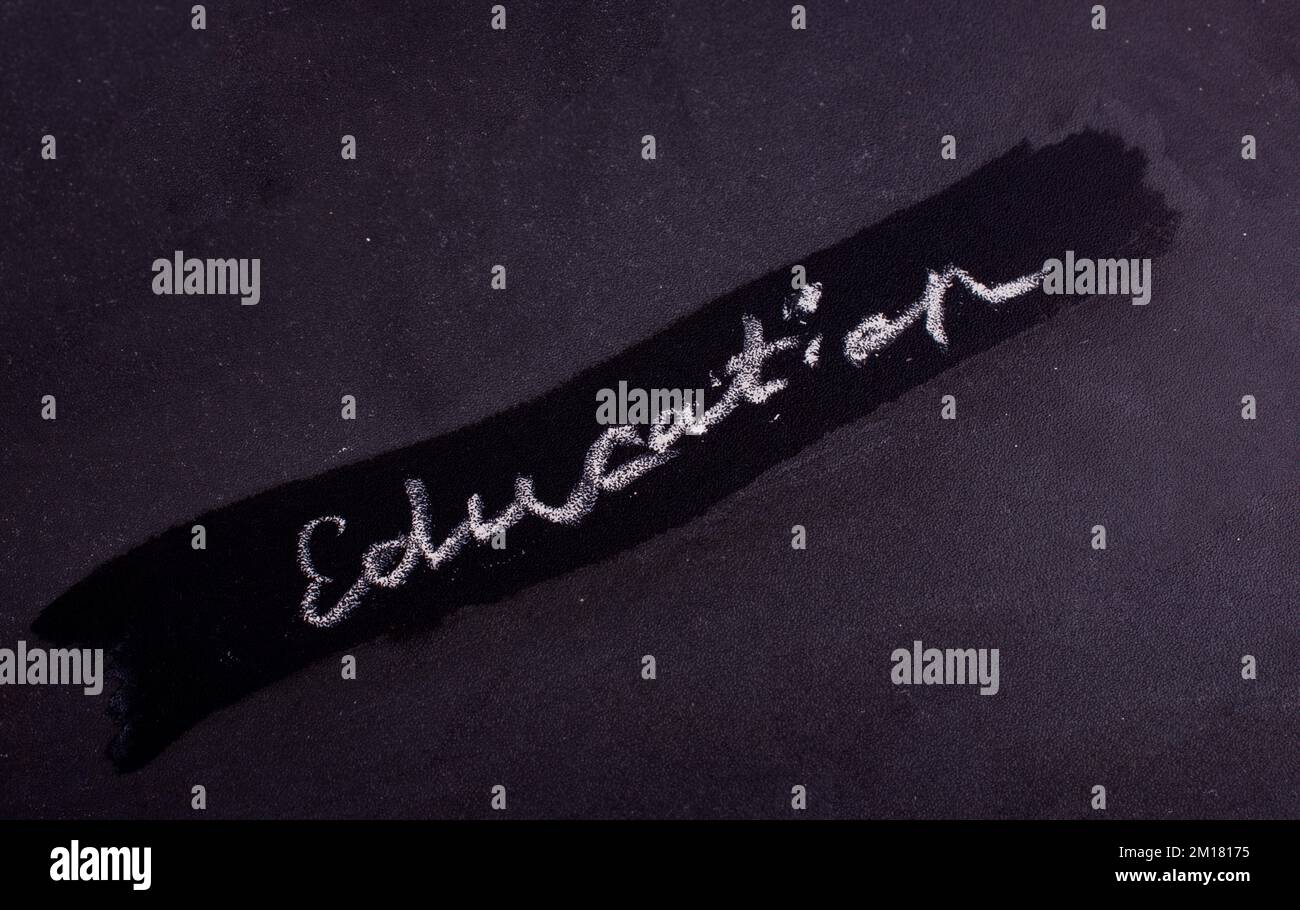 Hand written word EDUCATION with white chalk on black board Stock Photo ...