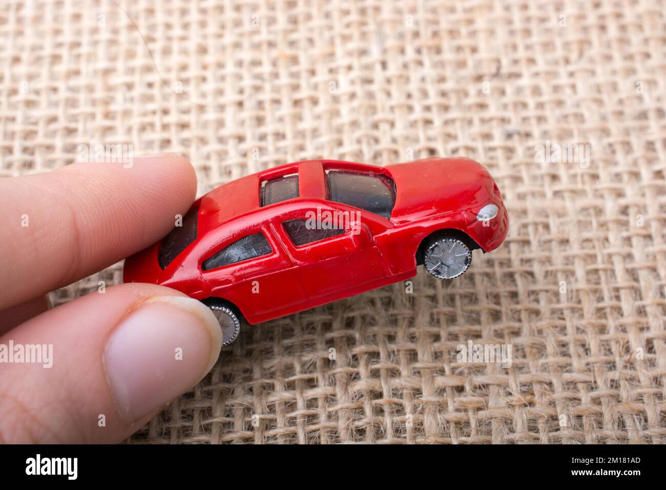 Colorful little toy car in hand on white background Stock Photo - Alamy