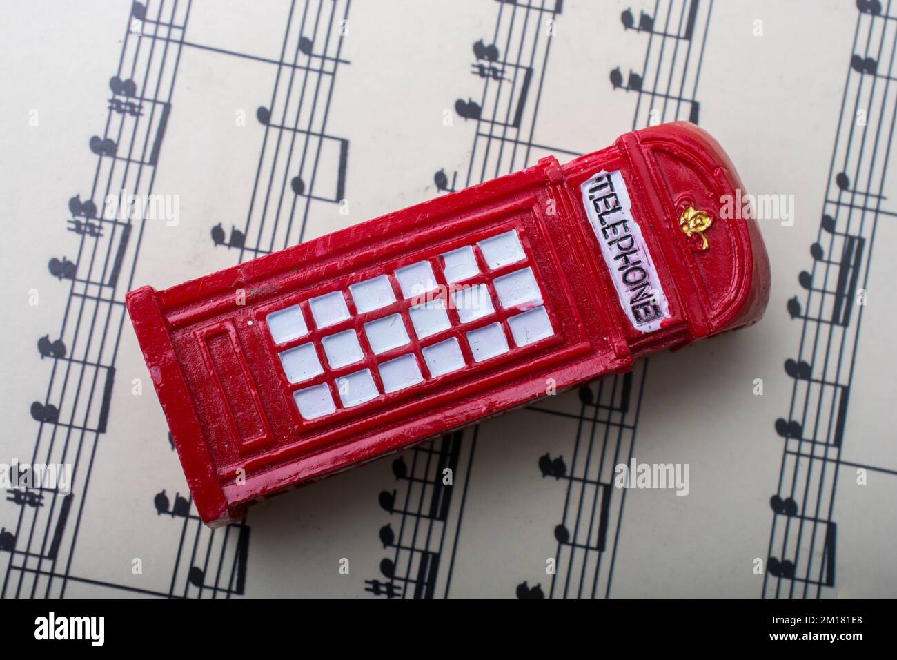 Telephone booth is placed on paper with musical notes Stock Photo - Alamy