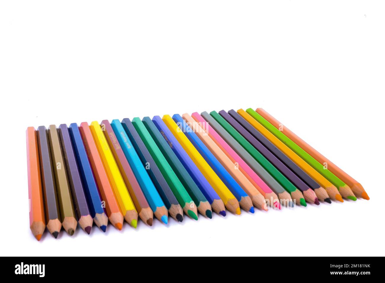 Colour pencils lined up on white background Stock Photo - Alamy