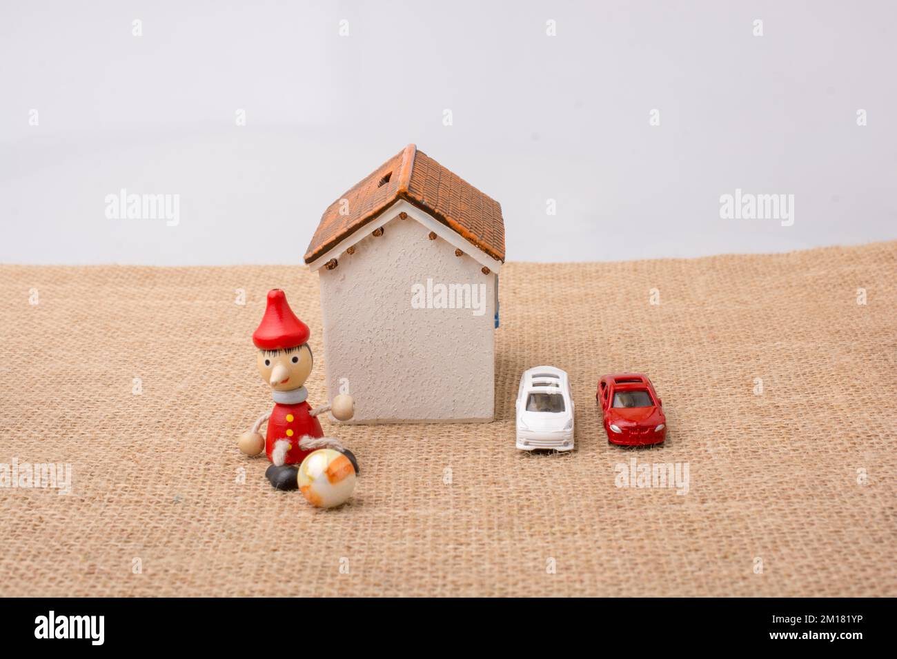 Little model house with cars and Pinocchio Stock Photo - Alamy