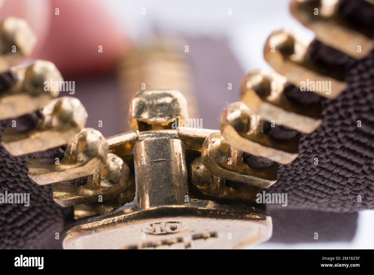 Close up or macro of a brown zipper on white background Stock Photo - Alamy