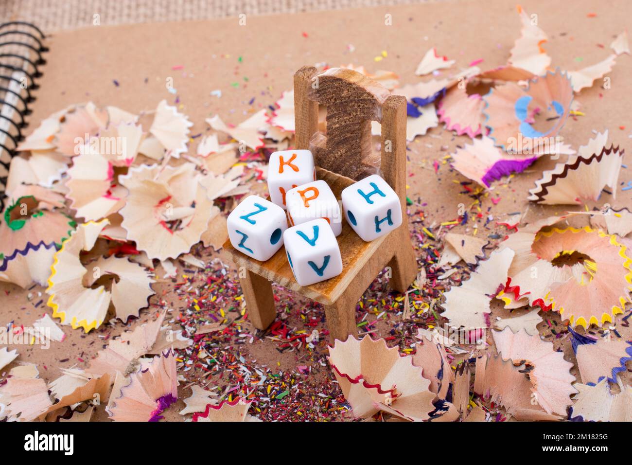 Colorful letter cubes on chair in pencil trash Stock Photo - Alamy