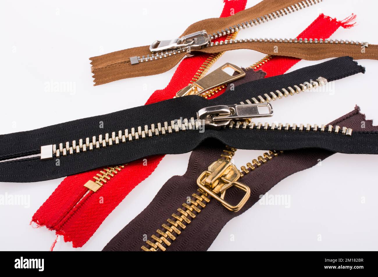 Color zippers on a white background Stock Photo - Alamy