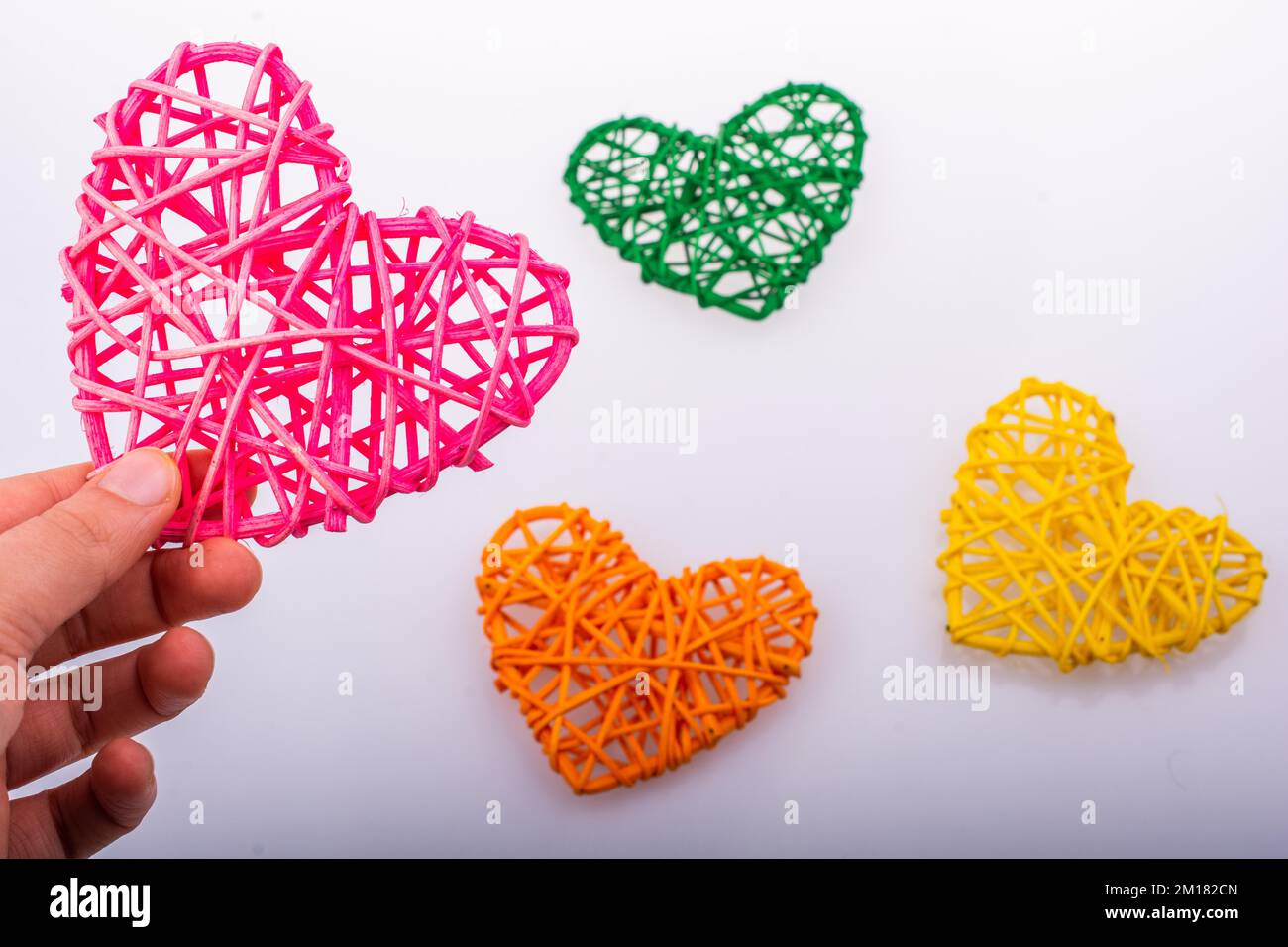Handmade straw heart or valentines day object in hand Stock Photo - Alamy