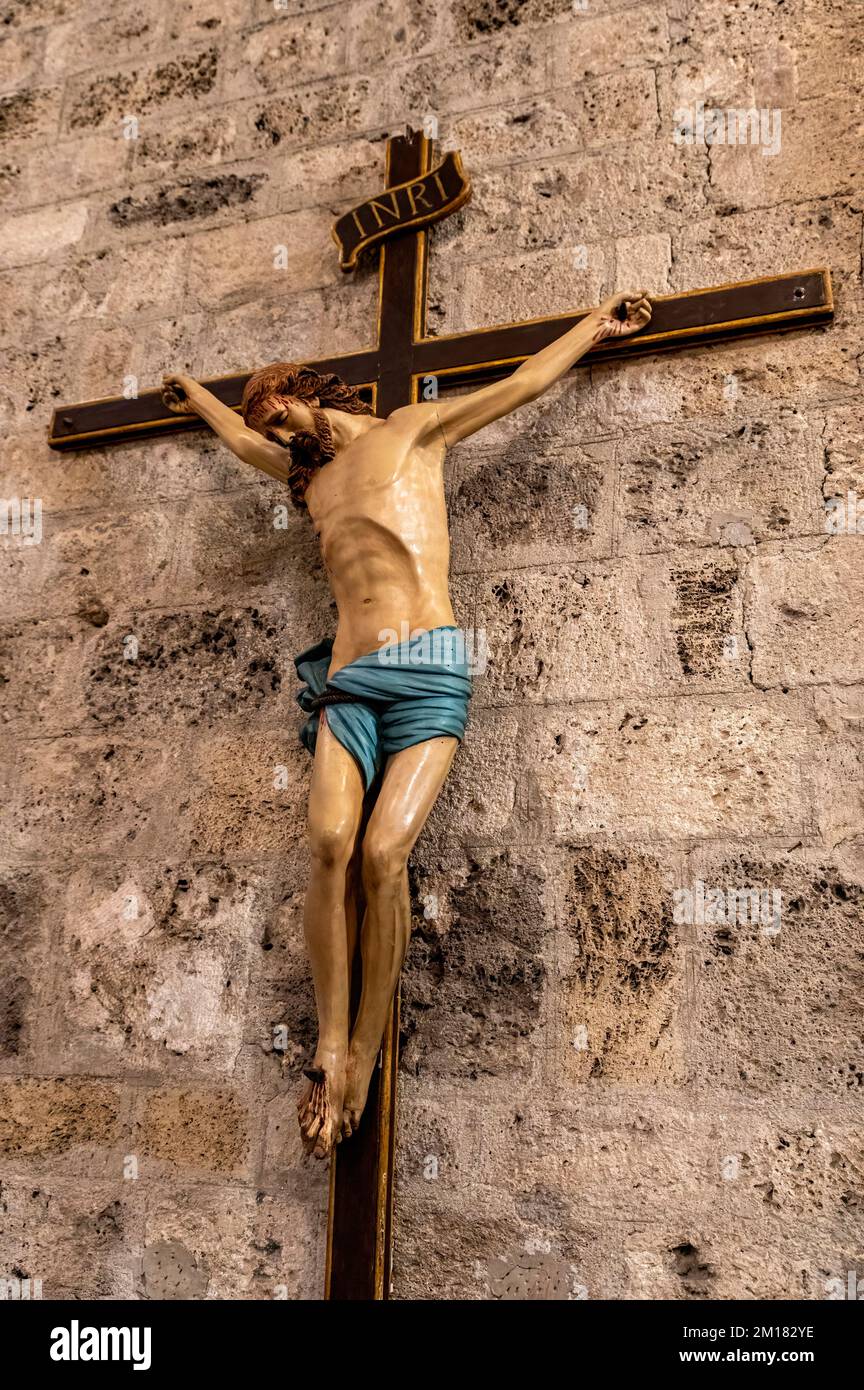 crucified on the wall of a church symbol of jesus Stock Photo - Alamy