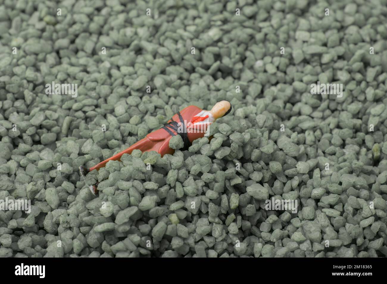 Tiny figurine of man miniature model tied in rope Stock Photo - Alamy