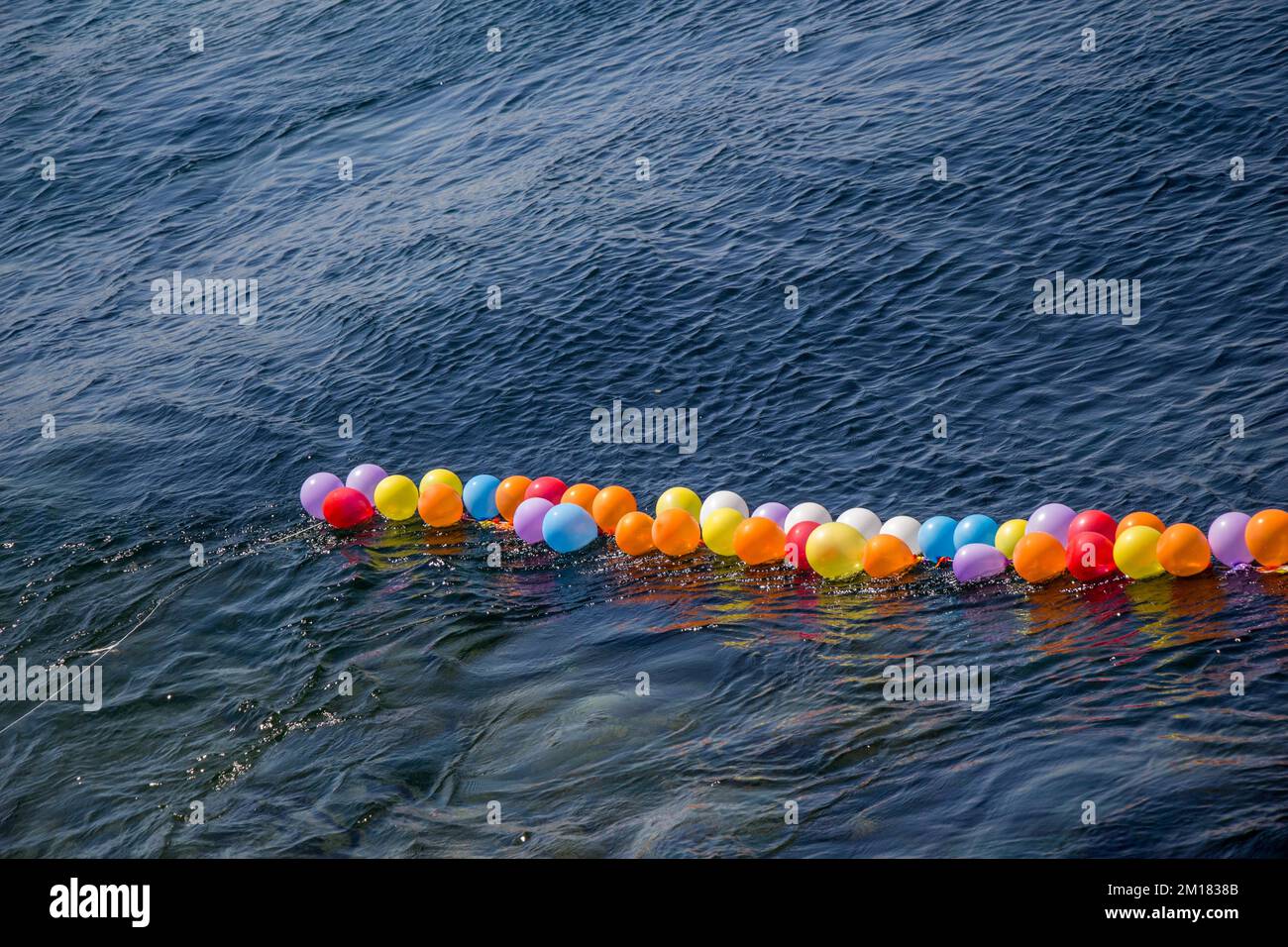 Balloon on a string on water for shooting game Stock Photo - Alamy