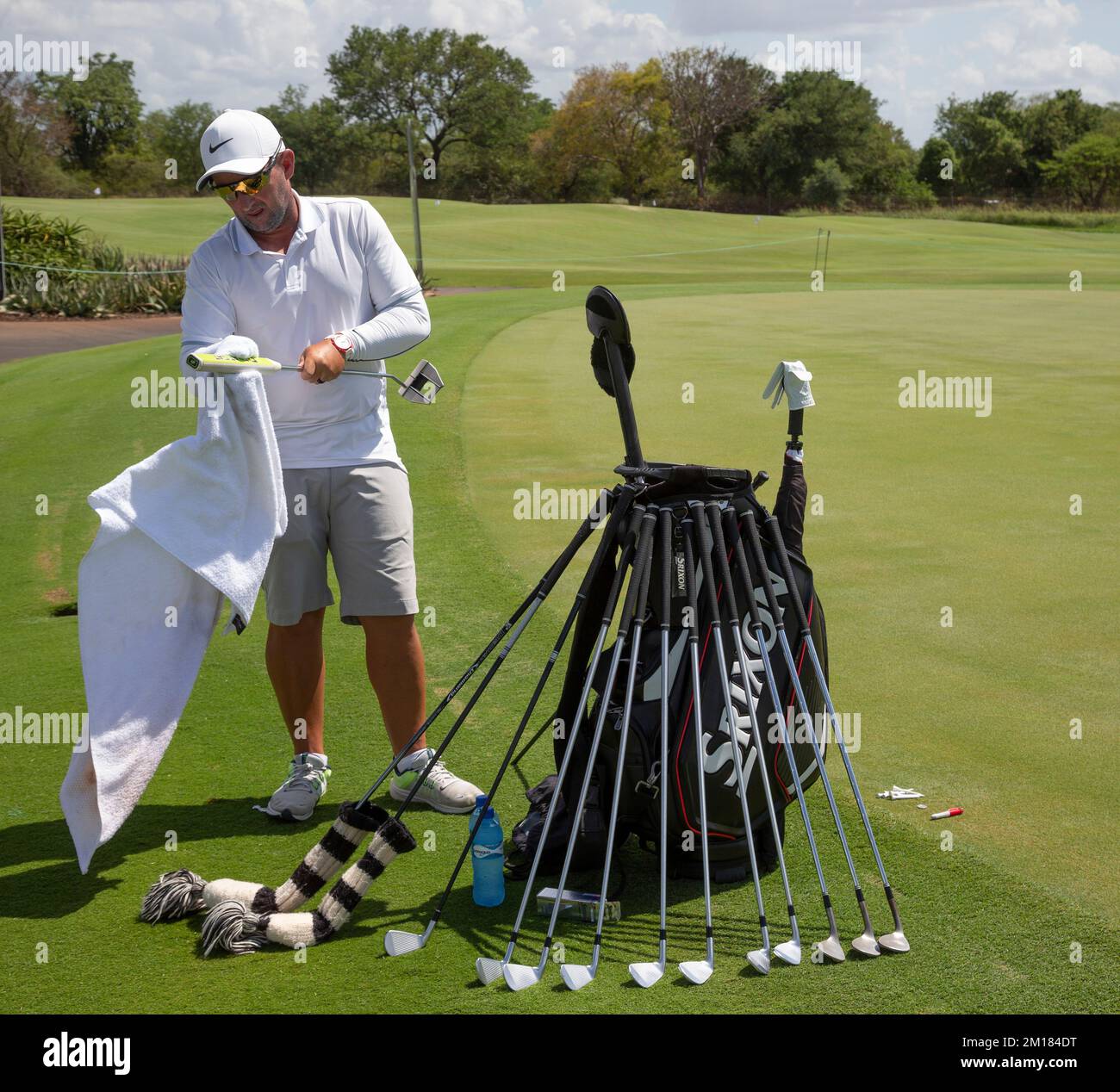 Professional golf caddy preparing the clubs for the third round on 10 ...