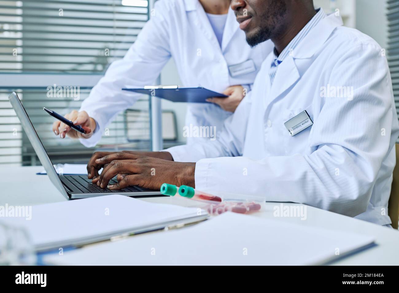 Close up of scientist using laptop while doing research in medical lab ...