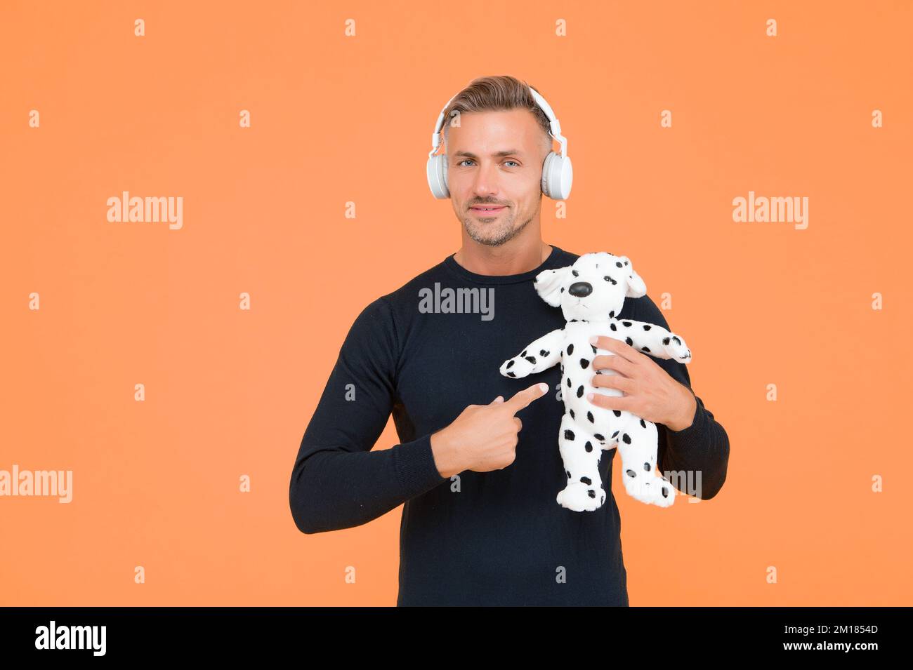 Its more then a toy. Handsome man point finger at toy dog. Toyshop ...