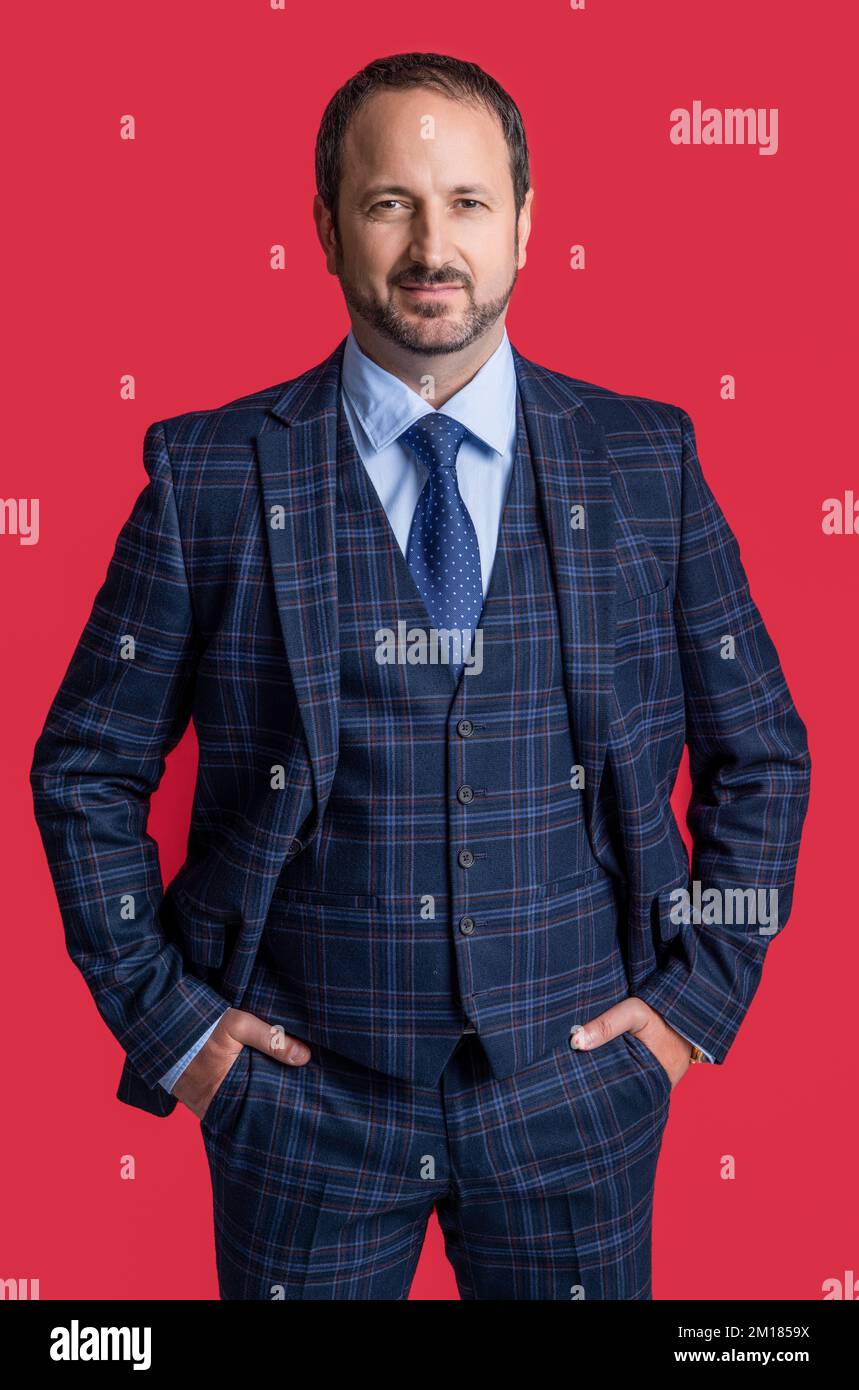 mature man director in business suit isolated on red background ...
