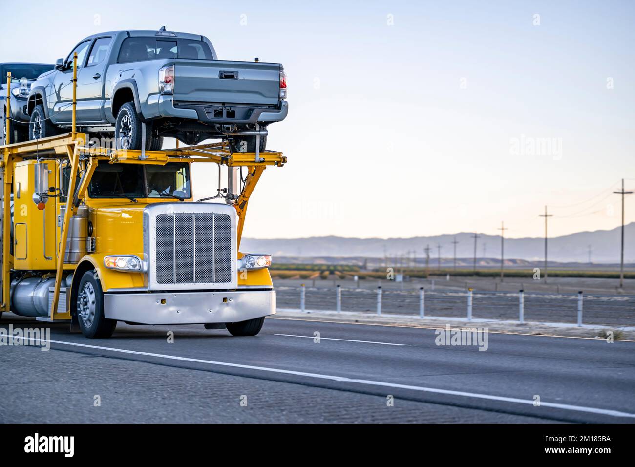 Industrial big rig yellow car hauler semi truck with chrome parts ...