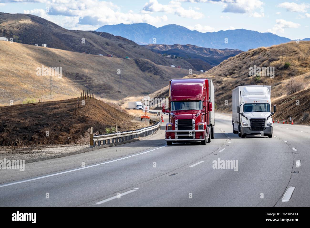 Convoy of a industrial transportation burgundy and white two different ...