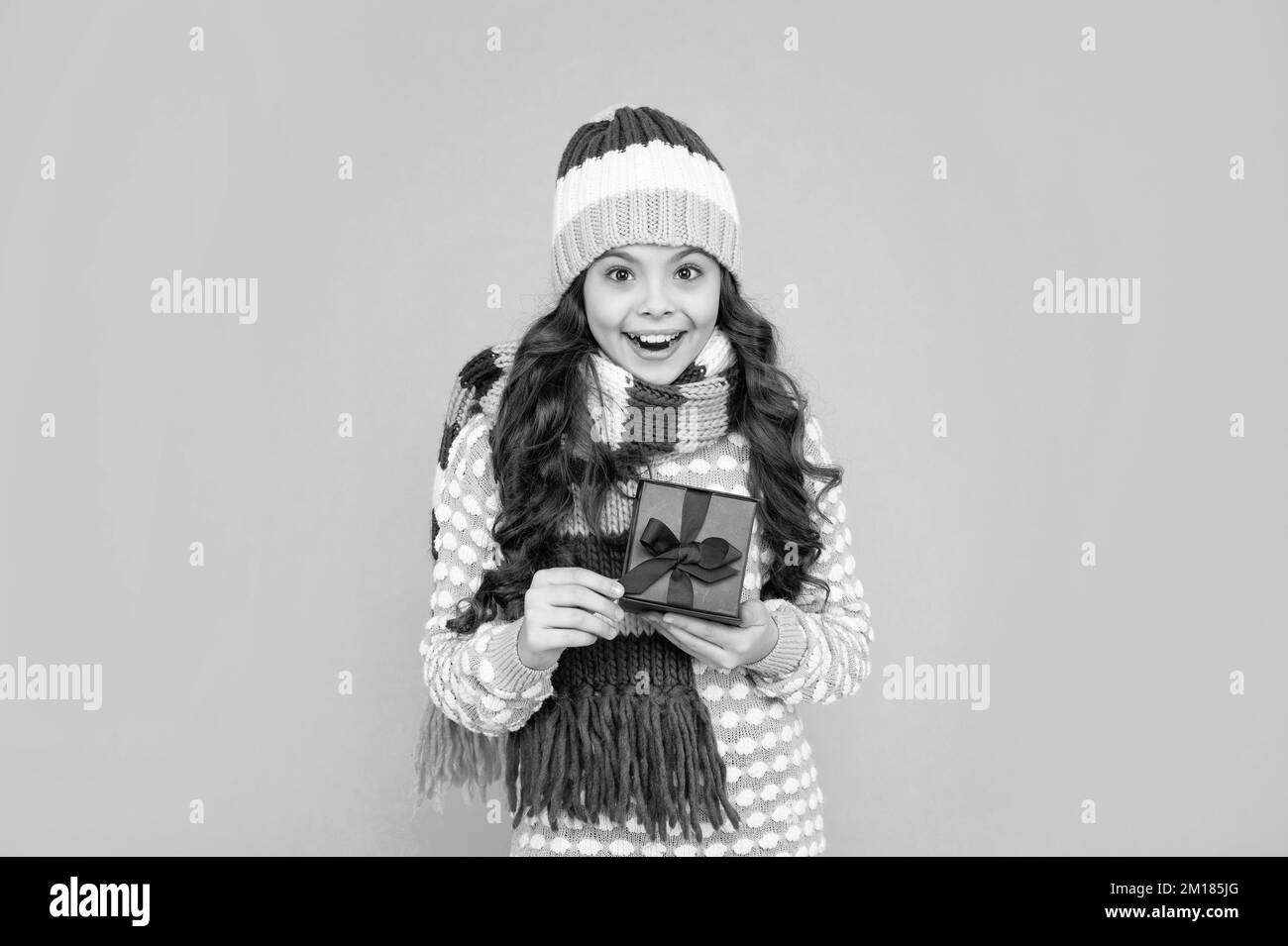 surprised happy child in knitwear hold box. kid with present. teen girl ...