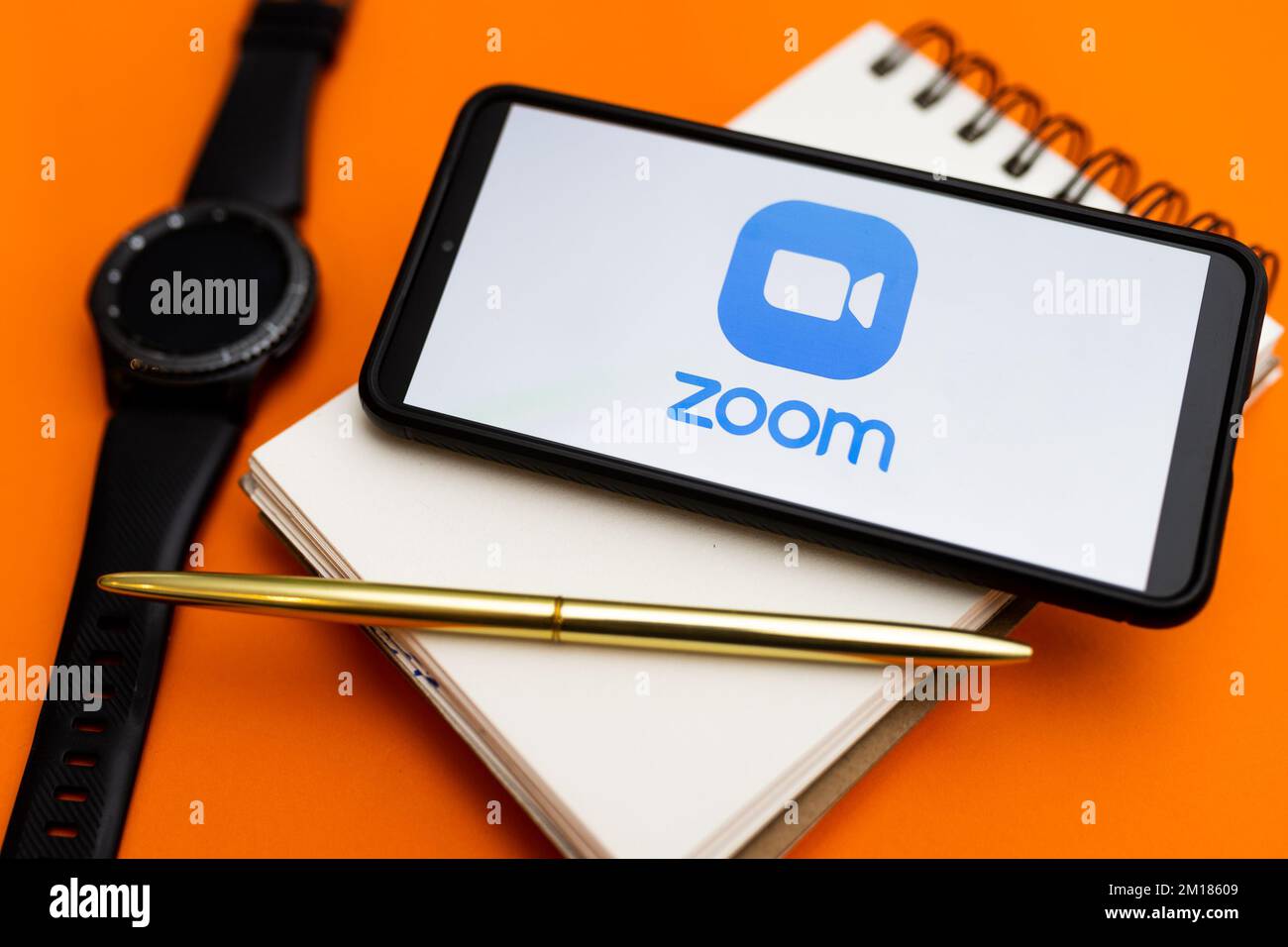 In this photo illustration a Zoom logo seen displayed on a smartphone ...