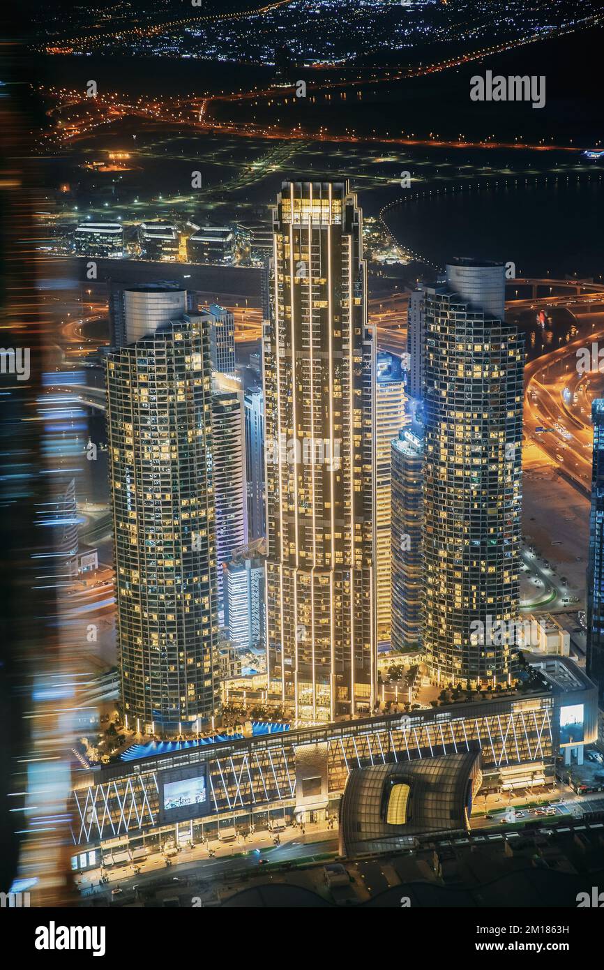Abstract blurred bokeh boke background of illuminated cityscape with skyscrapers in Dubai ...