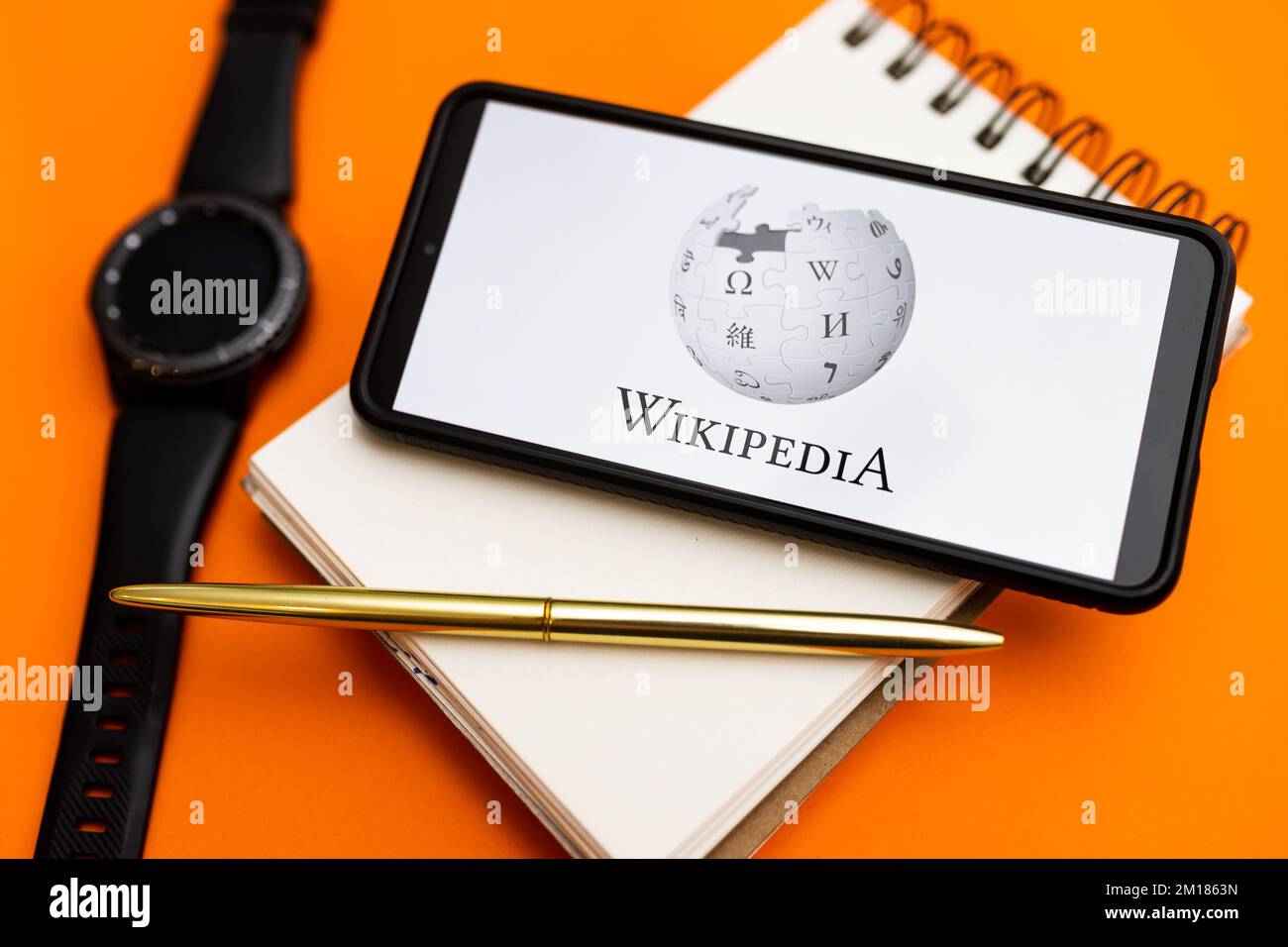 In this photo illustration a Wikipedia logo seen displayed on a ...