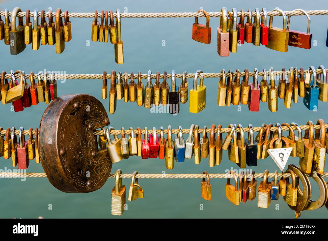 Many colorful locks are locked at a steel cable for a love vow Stock ...
