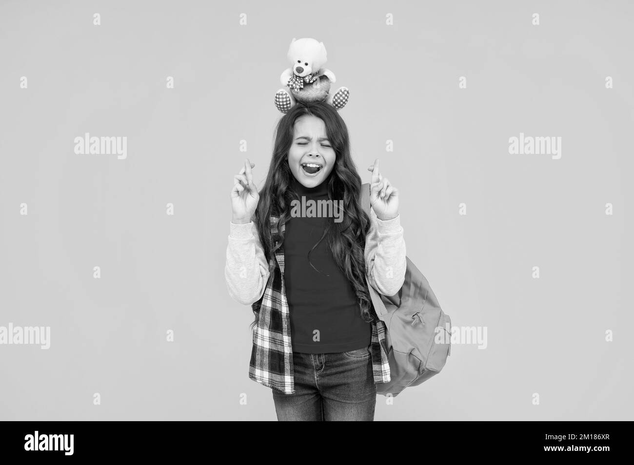 glad kid has long curly hair carry school backpack hold toy on yellow ...