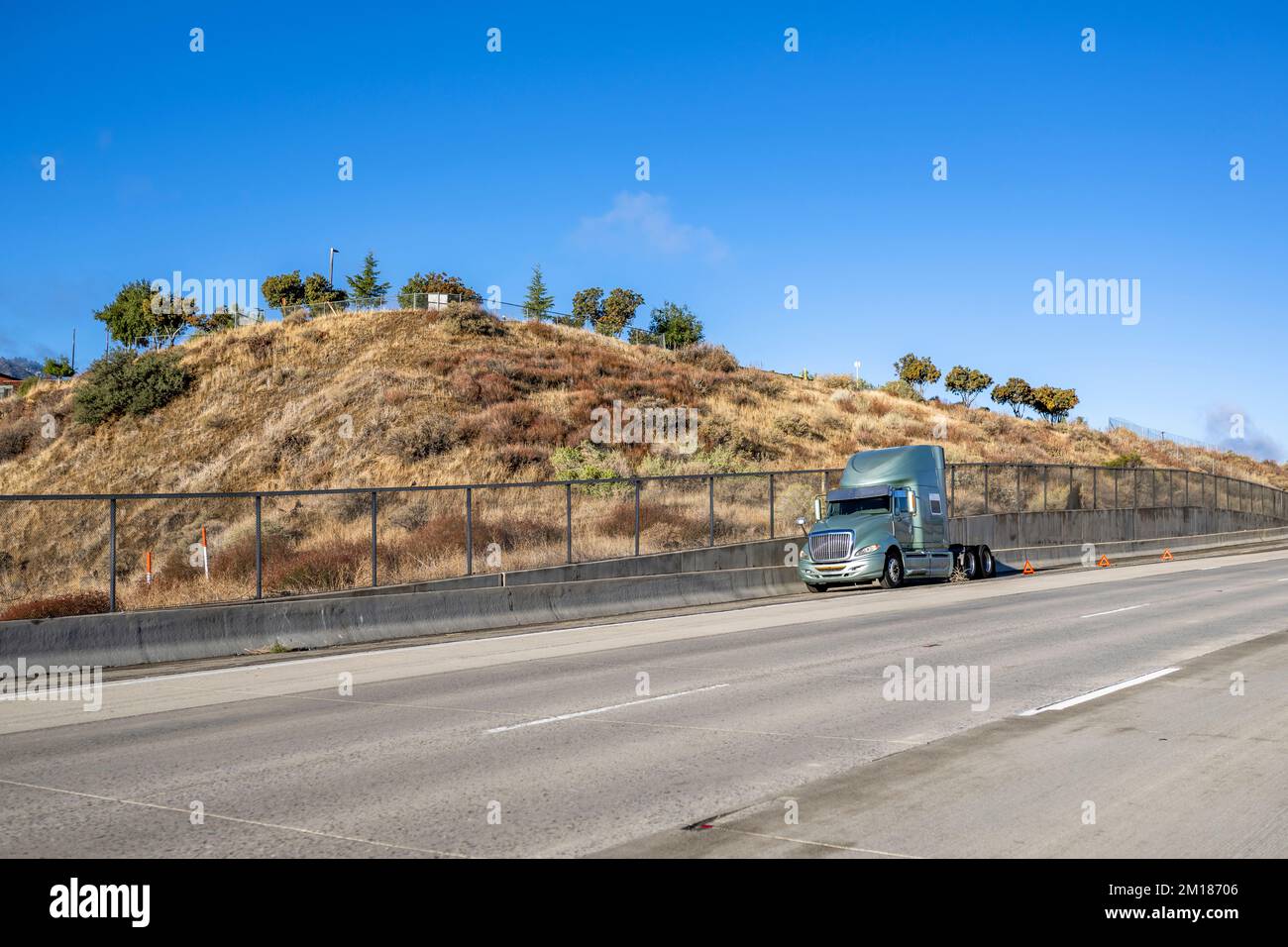 Broken big rig semi truck tractor with accident warning emergency signs ...